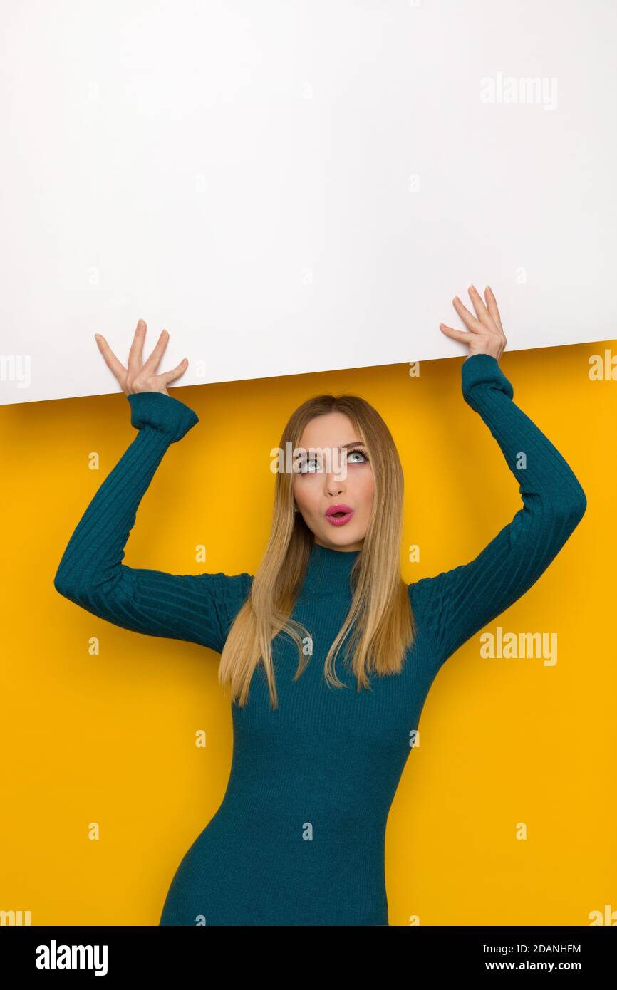 Woman holding sign above head hi-res stock photography and images - Alamy