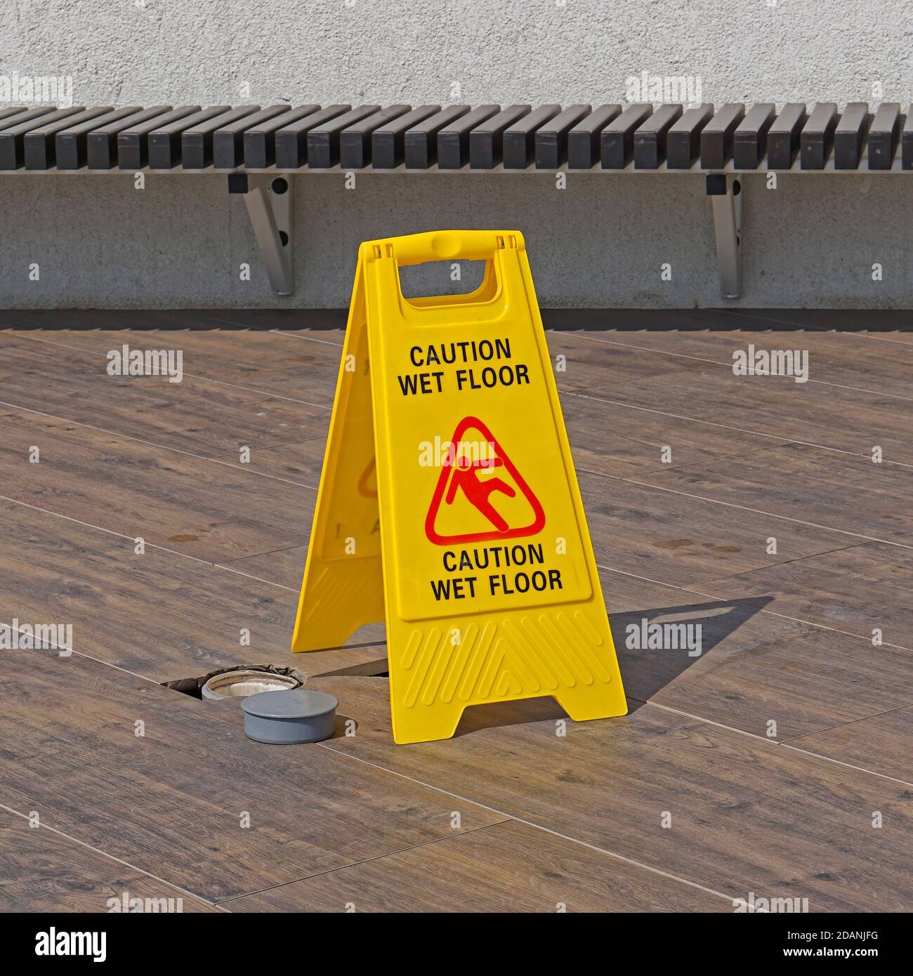 Wet floor sign at terrace patio caution Stock Photo - Alamy