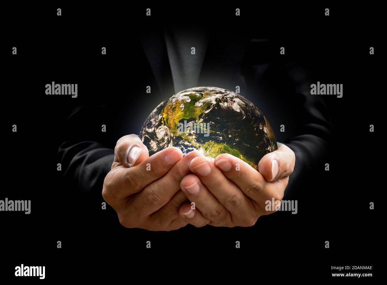 Environment concept. Earth in hands on black background. Elements of ...