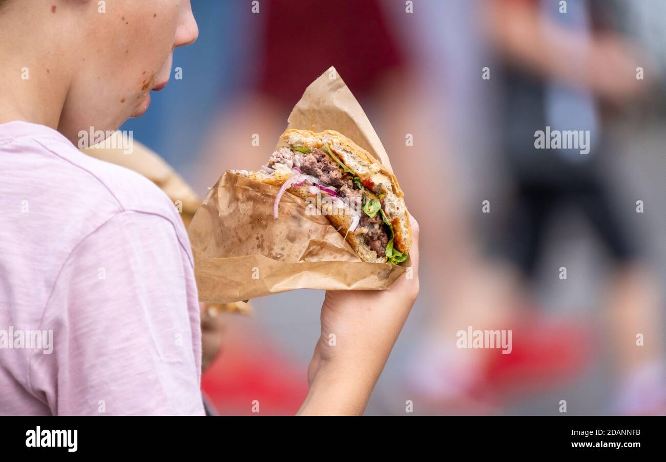 Anonymous child with delicious burger Stock Photo - Alamy