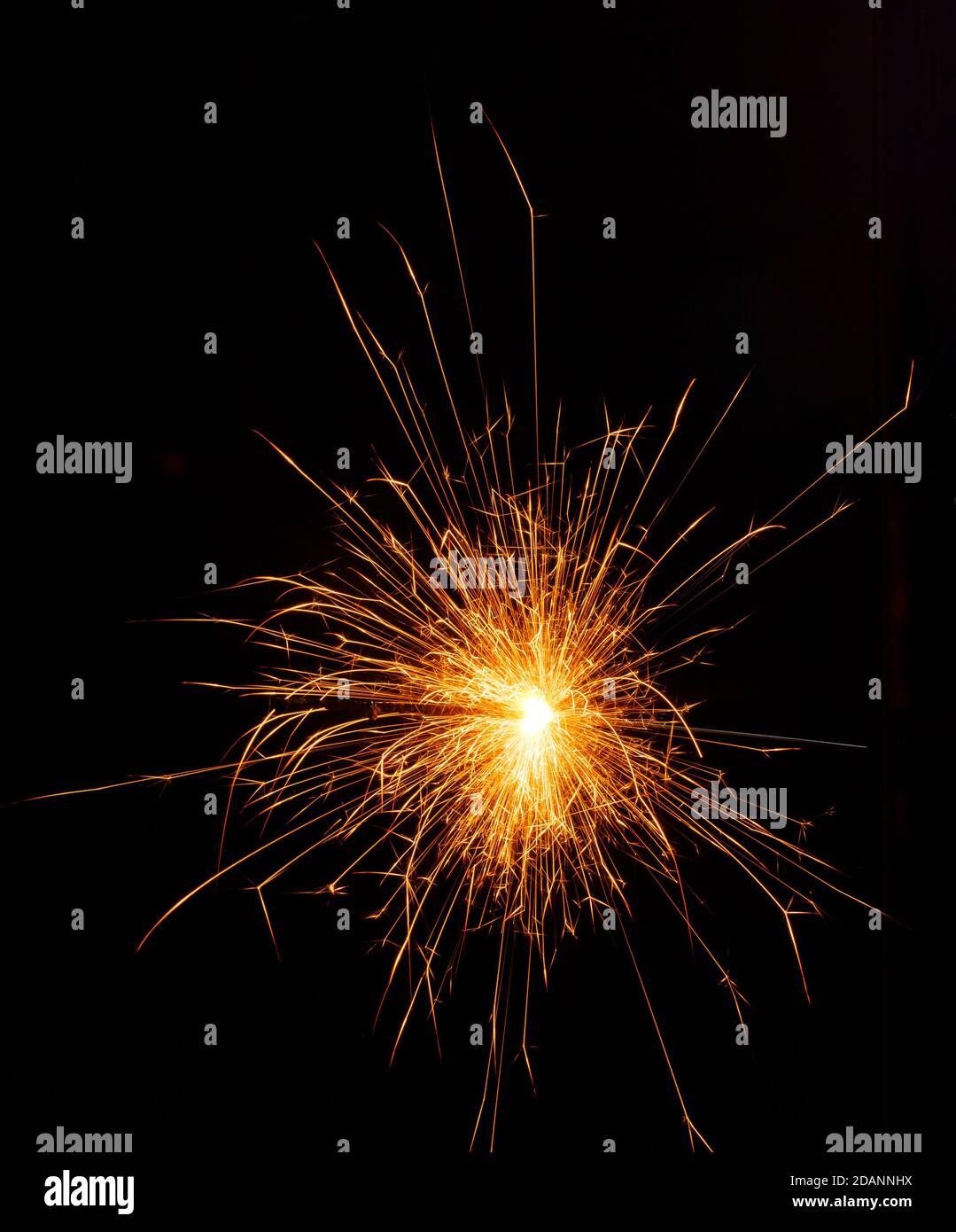 A lit sparkler showing bright sparks desing abstract Stock Photo - Alamy