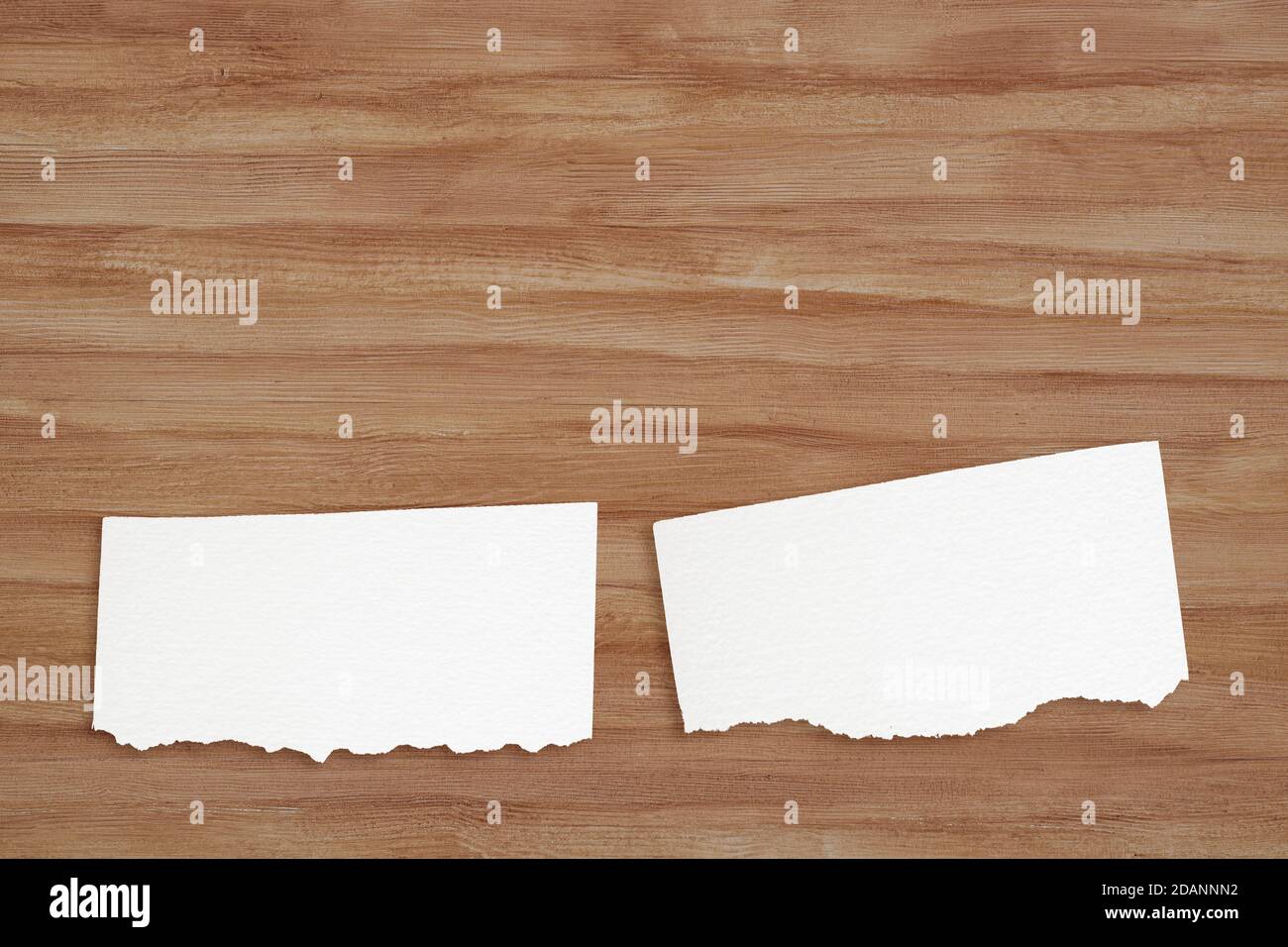 Blank white paper pad on wood desk background with copy space. Top down ...