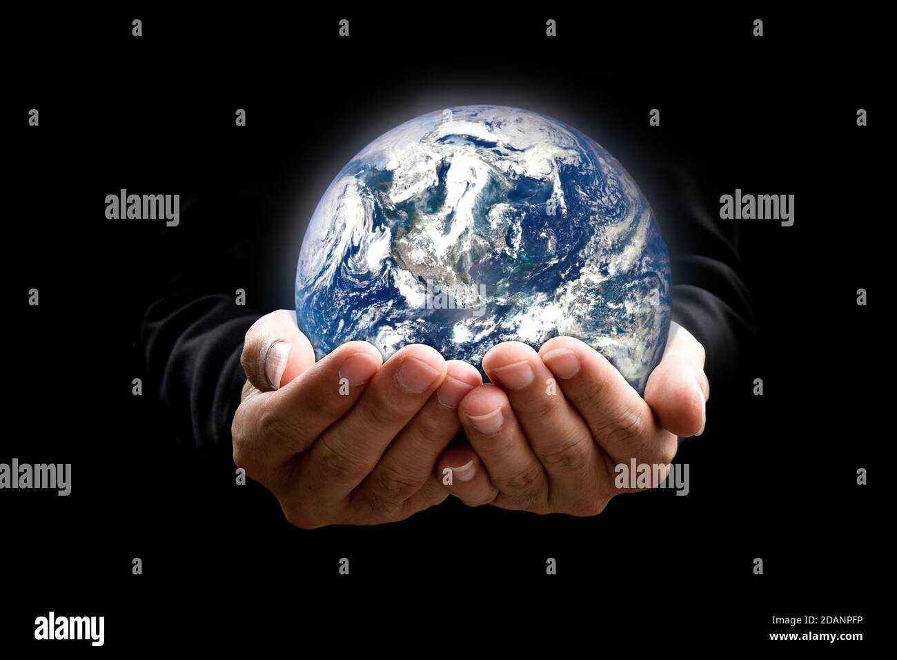 Environment concept. Earth in hands on black background. Elements of ...