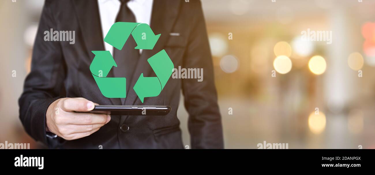 Businessman hand holding mobile phone with logo recycle icon. Concept ...