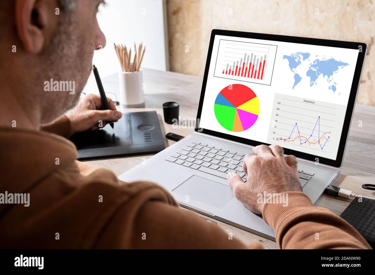 businessman analyzing statistics on laptop screen, working with financial graphs charts online ...