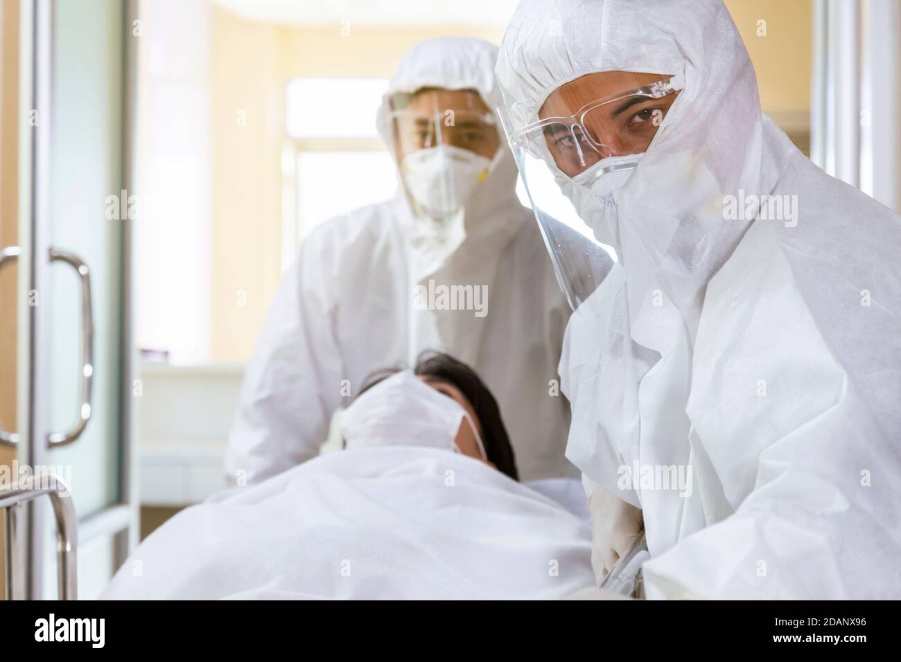 asian male nurse and doctor wearing ppe suit and face mask pushing ...