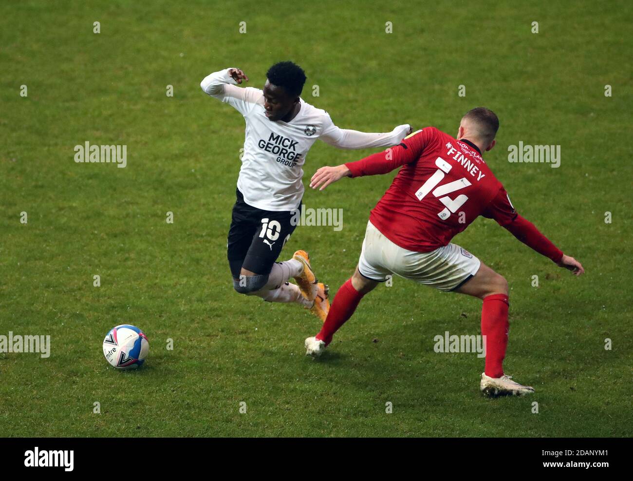 Peterborough United's Siriki Dembele (left) reacts to a challenge from ...