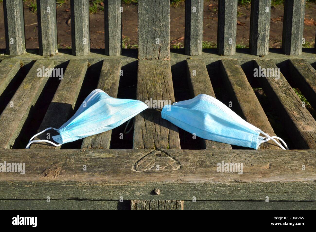Two surgical masks of a couple next to a heart, symbolizing couple and ...