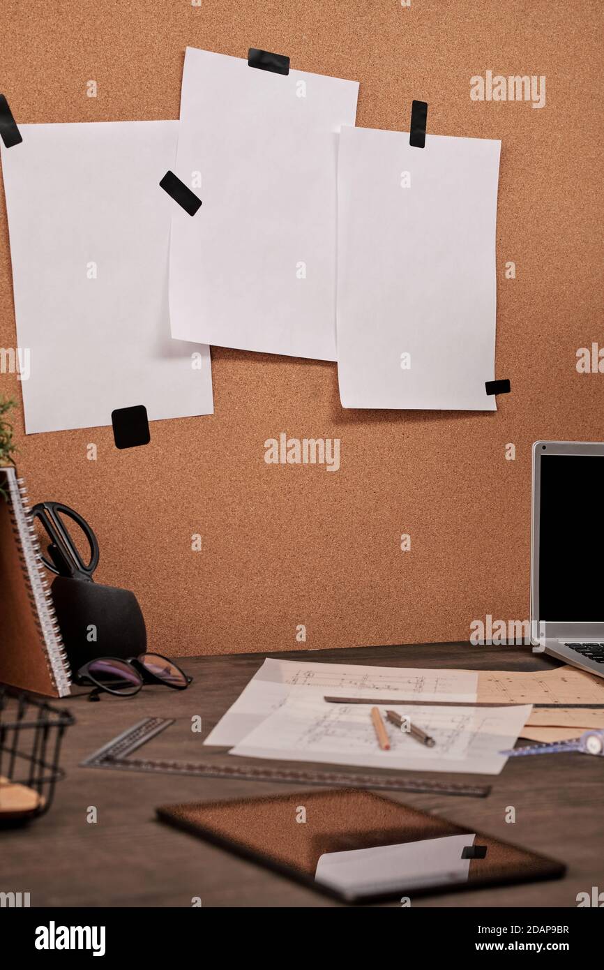 Workplace of modern engineer with blank papers on carton board in front ...