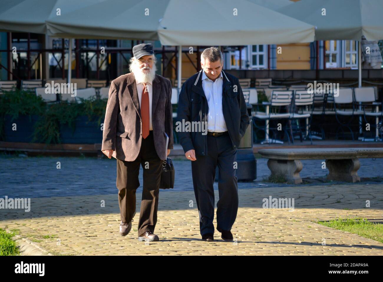 Timisoara, Romania - October 19, 2012: Two people walking on the street ...