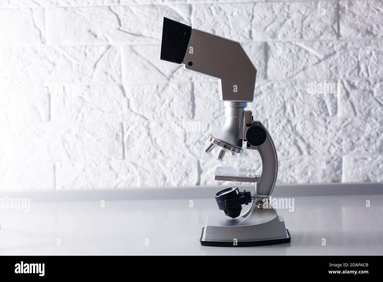 microscope stands on a table on a white background Stock Photo - Alamy