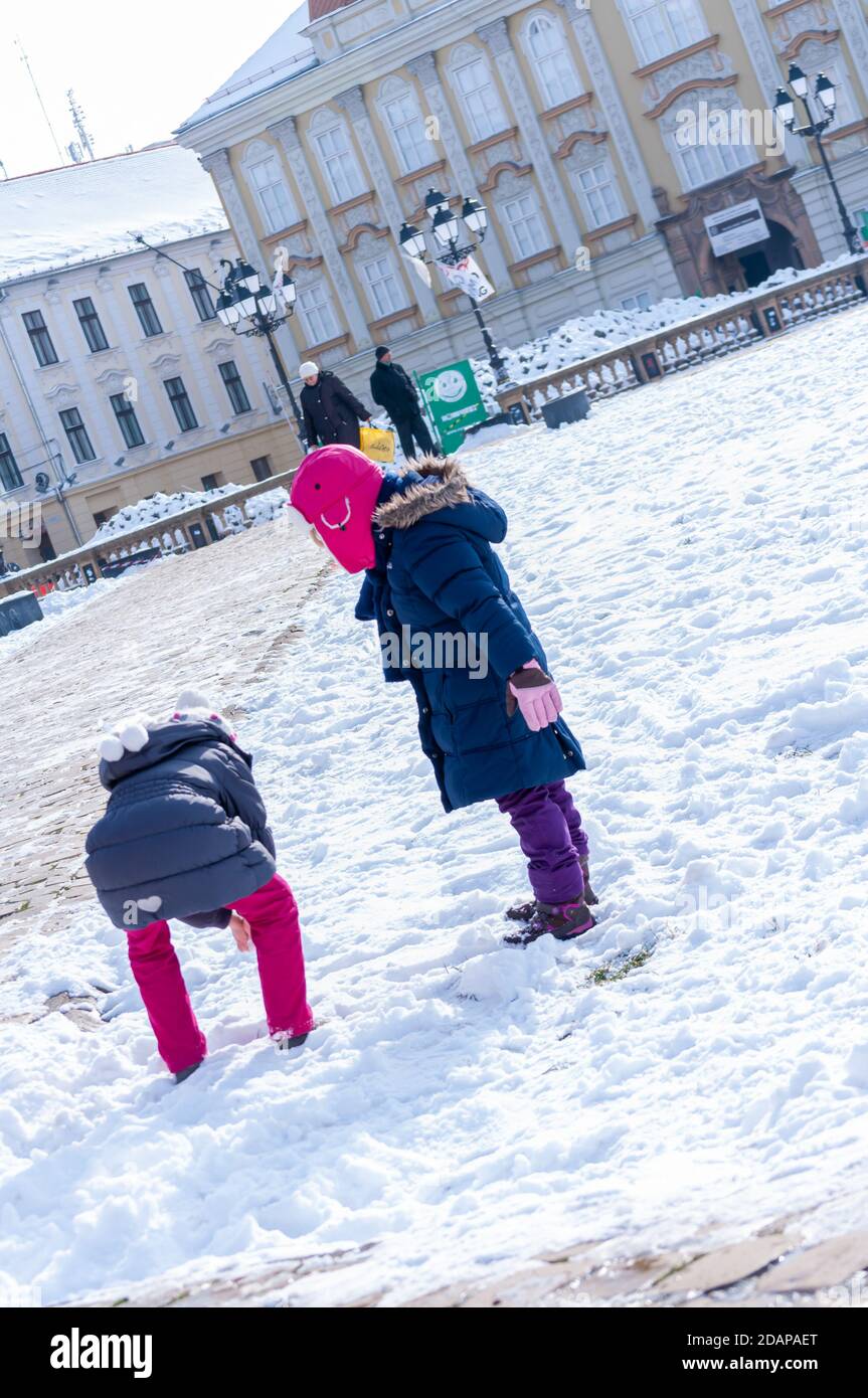 Timisoara, Romania - January 30, 2014: Kids playing with snow in the ...