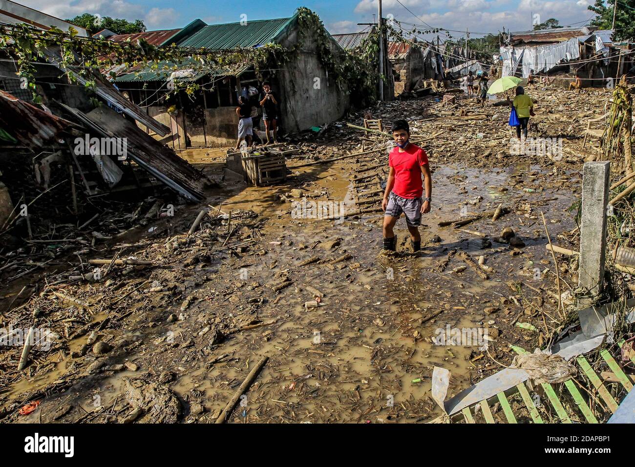 Rizal, Philippines. 14th Nov, 2020. A resident walks through the mud ...