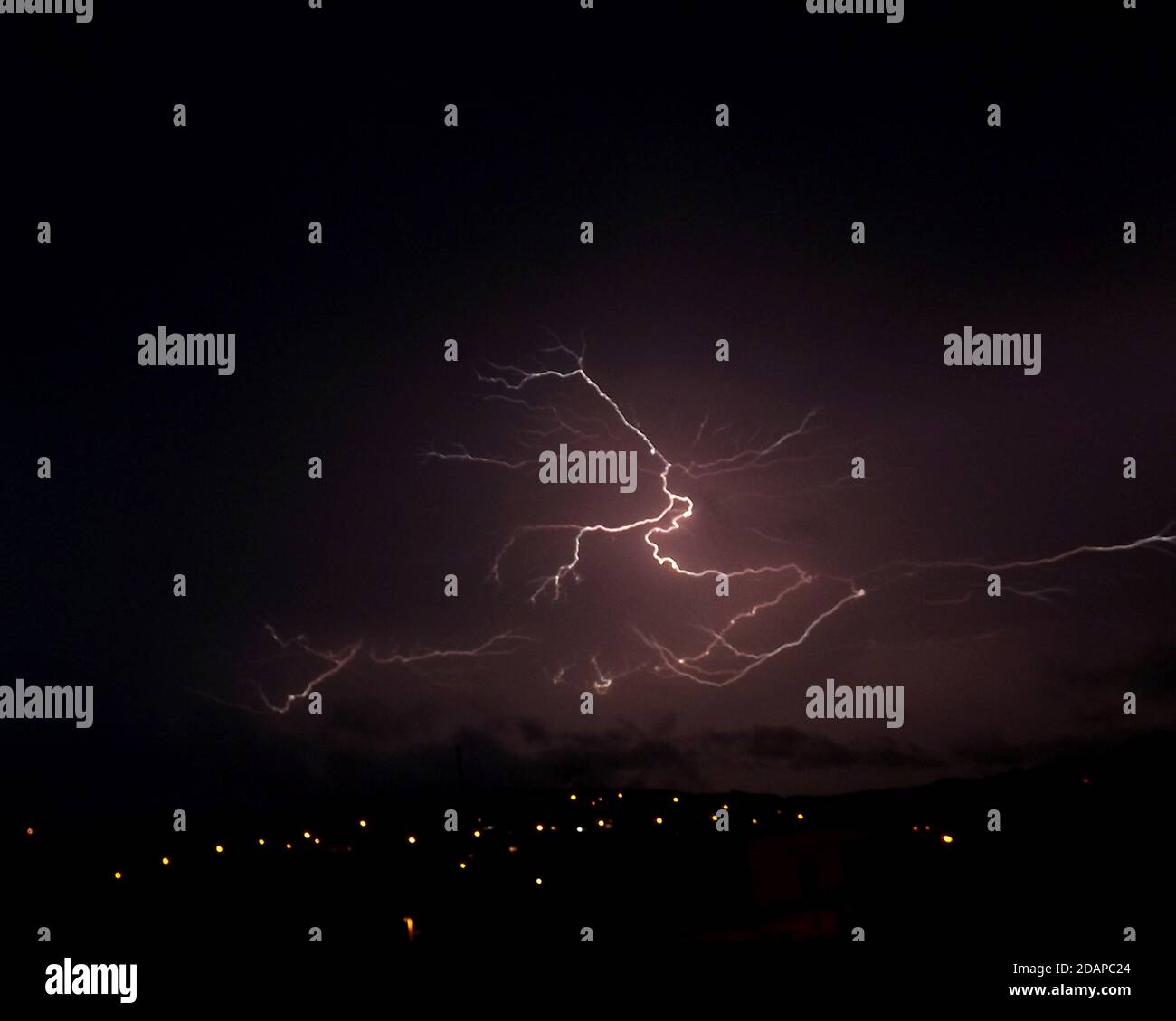 Night dark sky with a bright lightning strike over a city Stock Photo ...