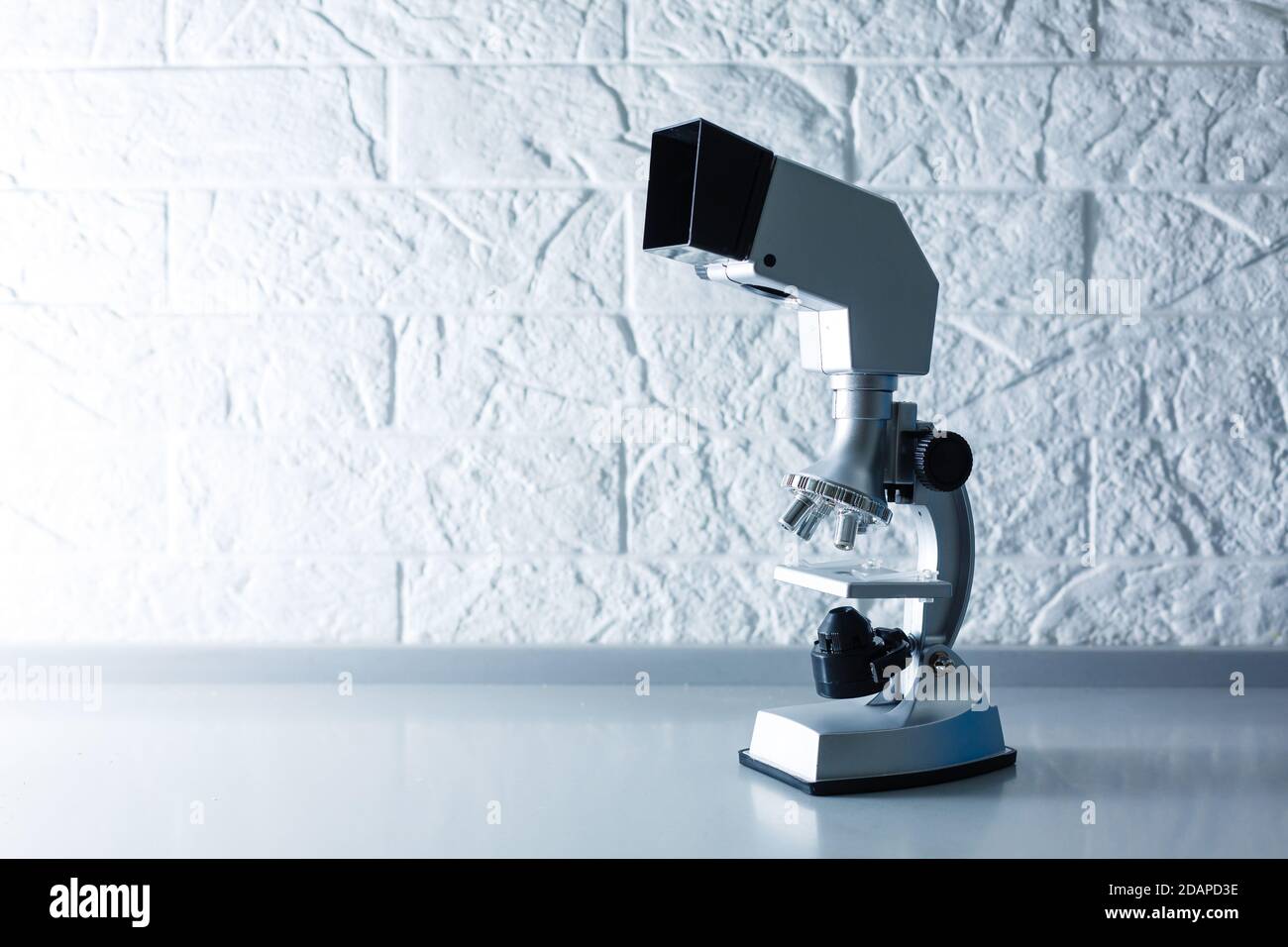 microscope stands on a table on a white background Stock Photo - Alamy