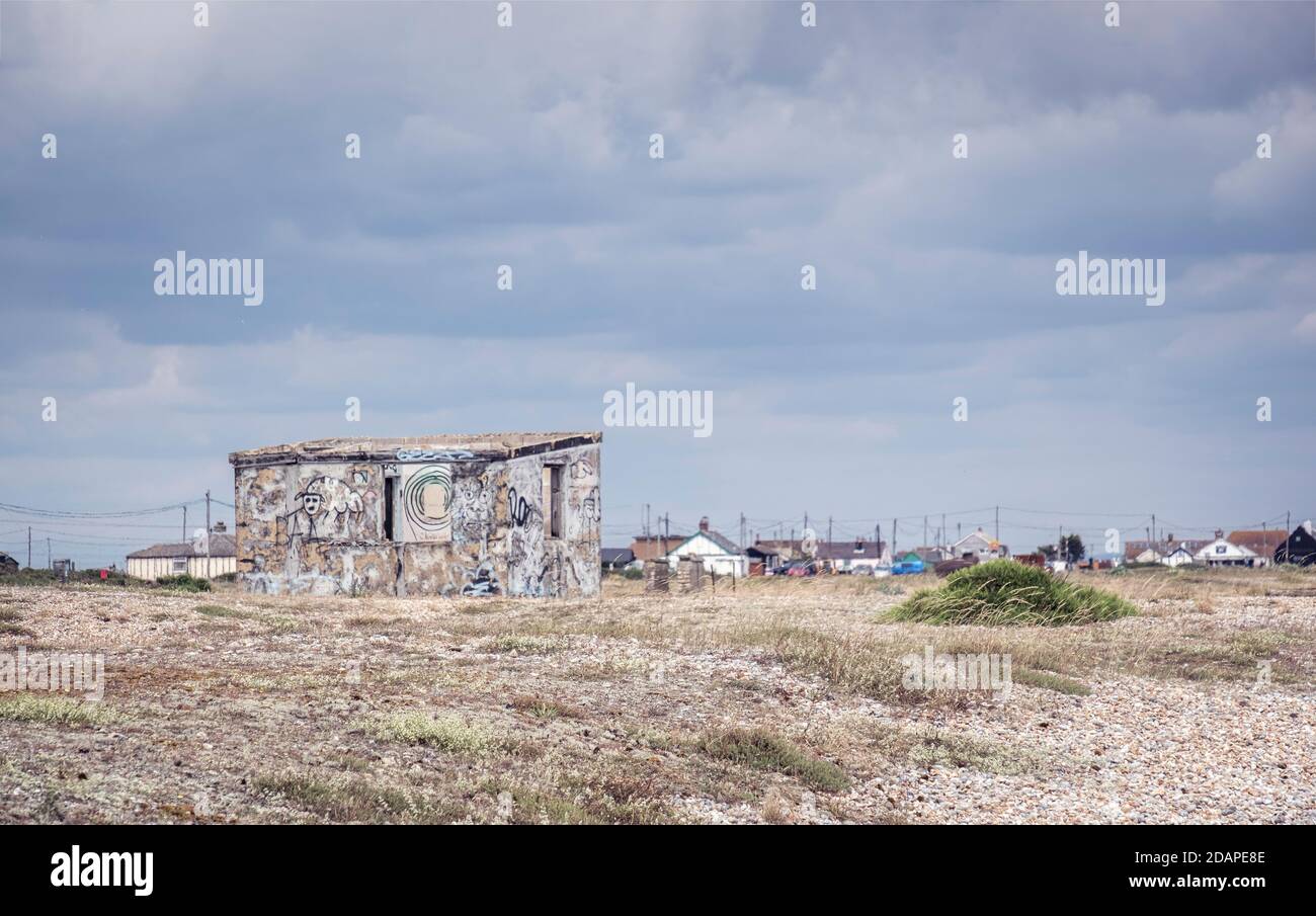 A graffitied shack on the stark landscape of Dungeness in Kent, UK ...