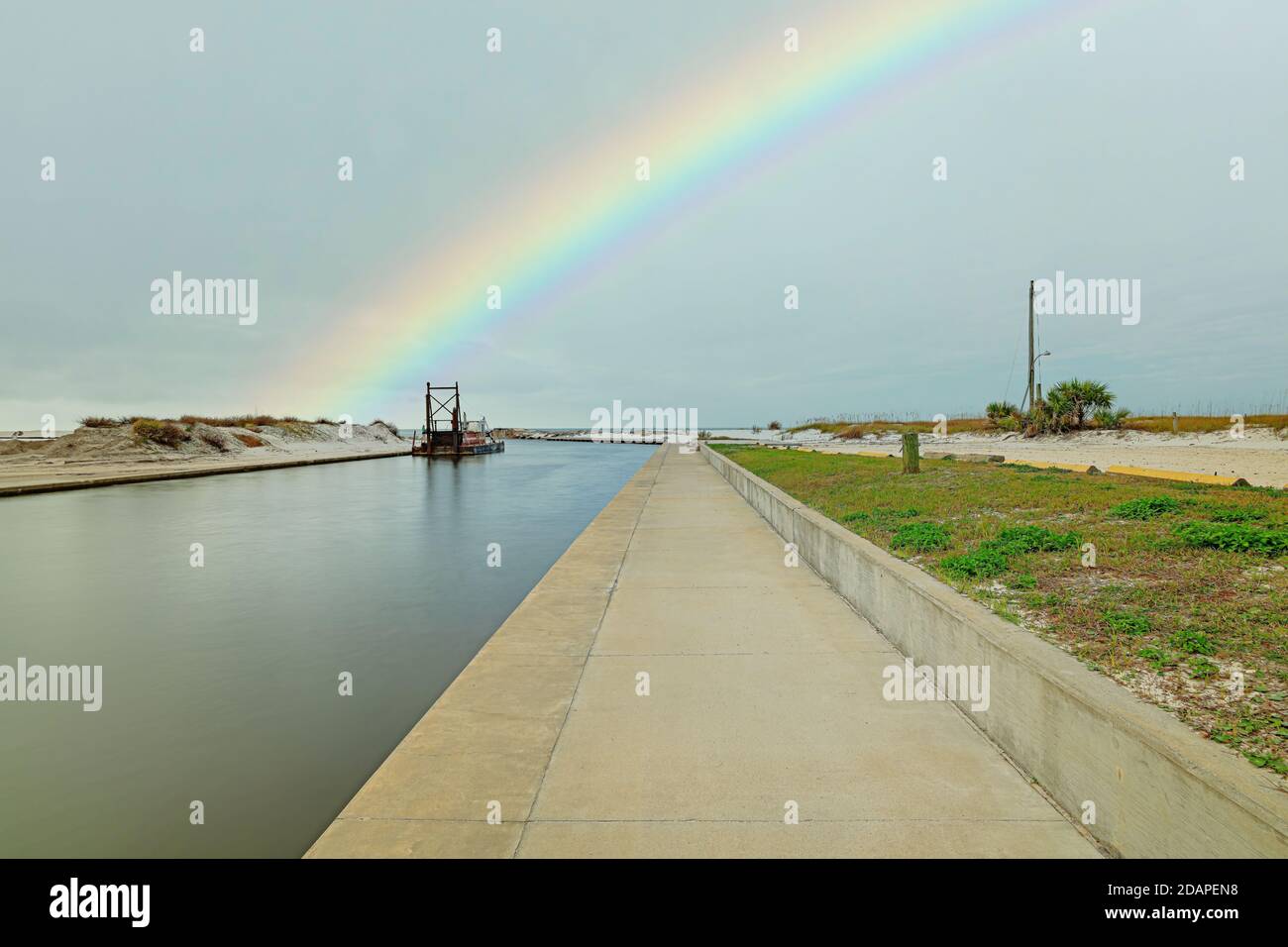 Dredging rig in the Mexico Beach, Florida canal with beautiful rainbow ...