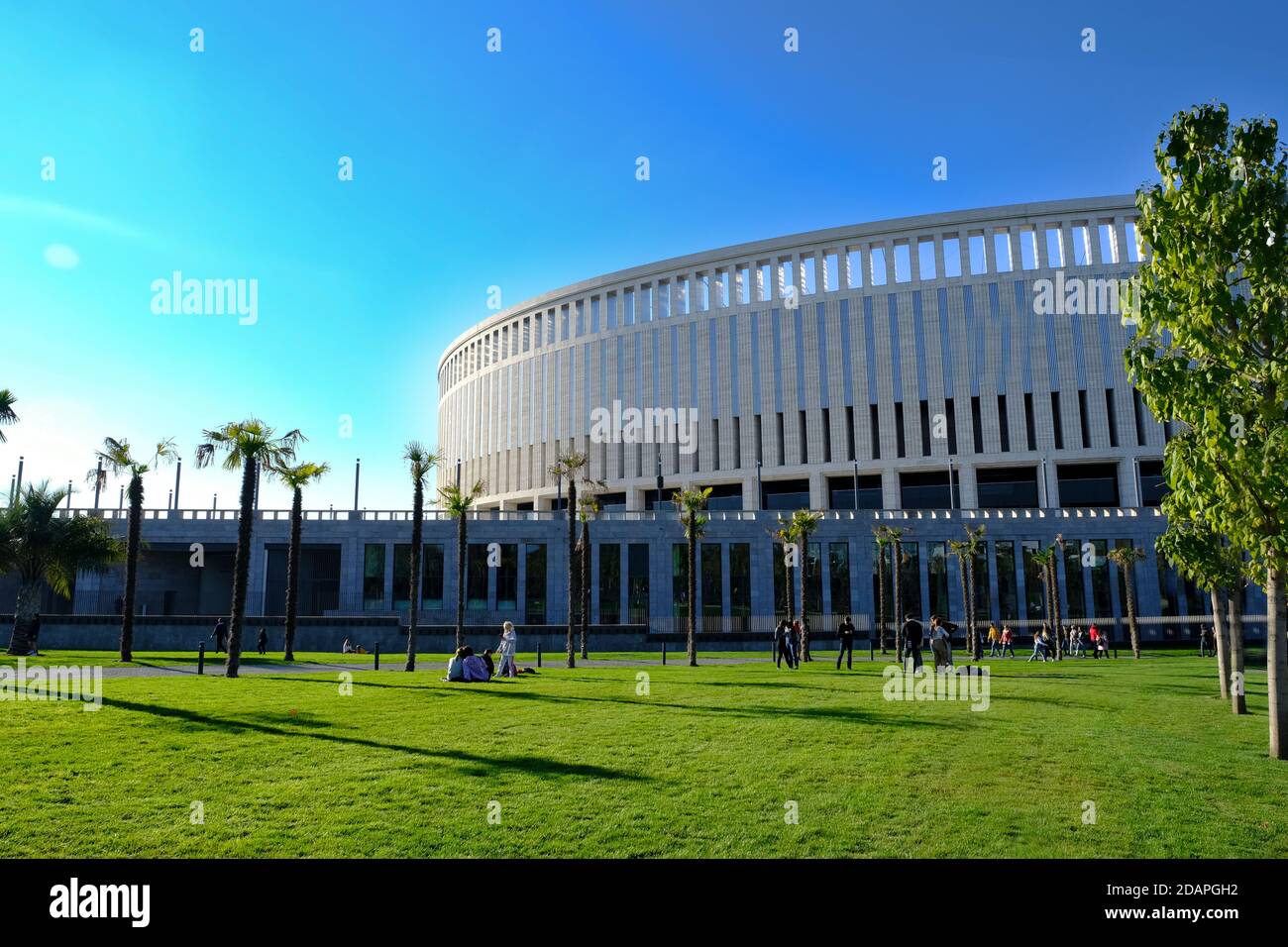 People walk in park as they keep the "social distance" each other.Green ...