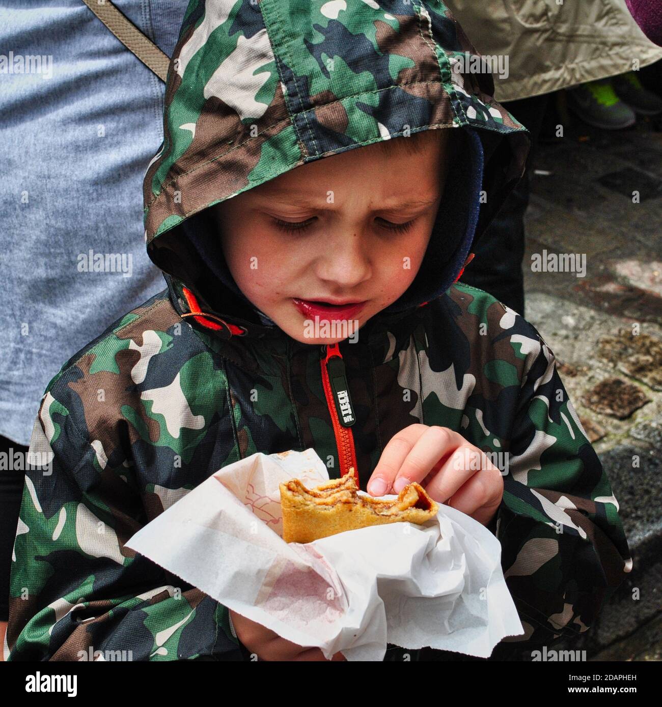Small boy eating crepe with nutella in Paris Stock Photo - Alamy