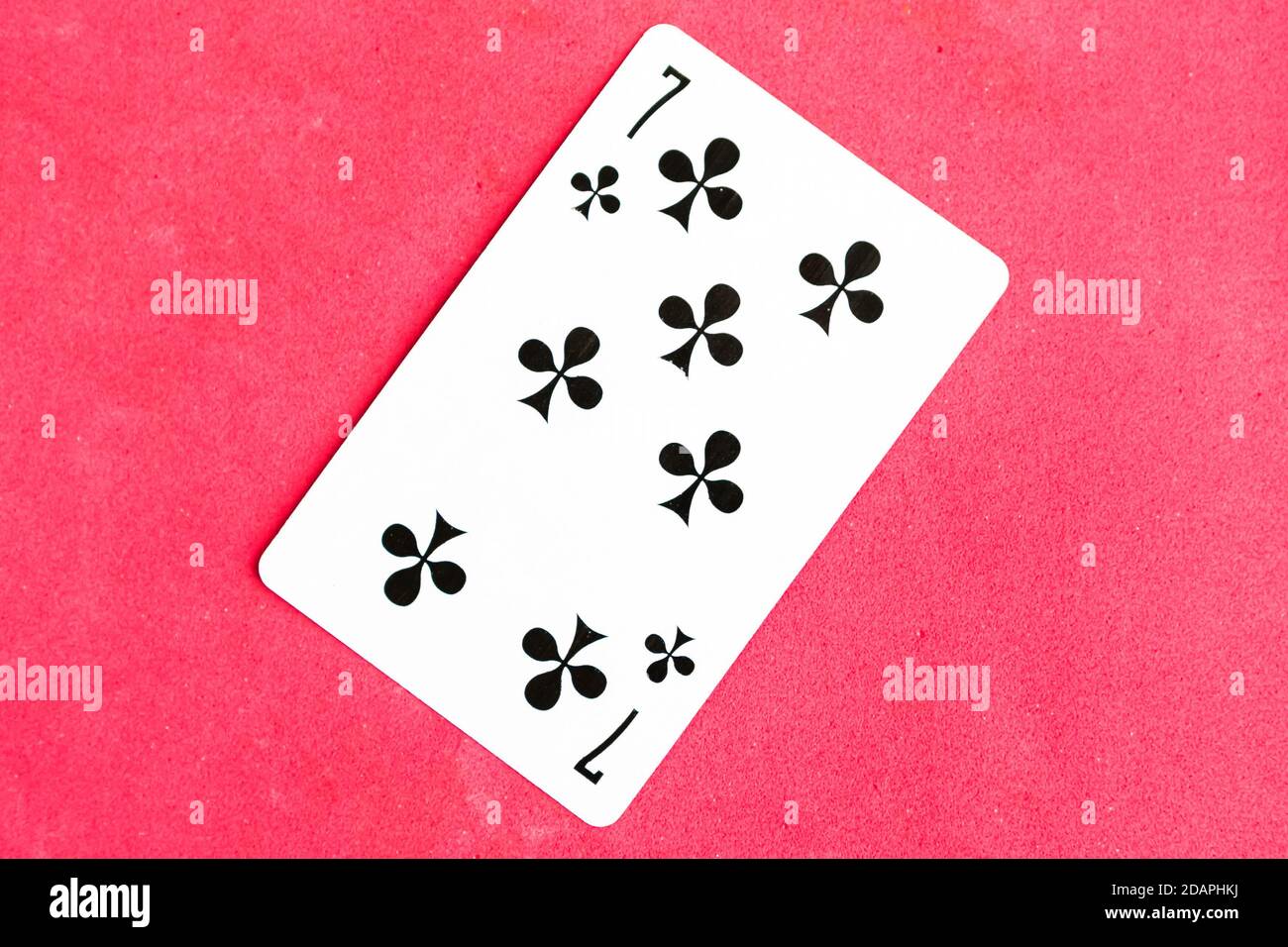 Seven of Club playing card, red background Stock Photo - Alamy