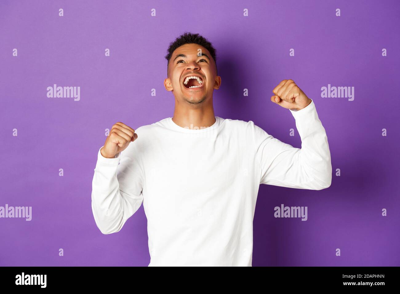 Image of happy and relieved african-american man, celebrating victory ...