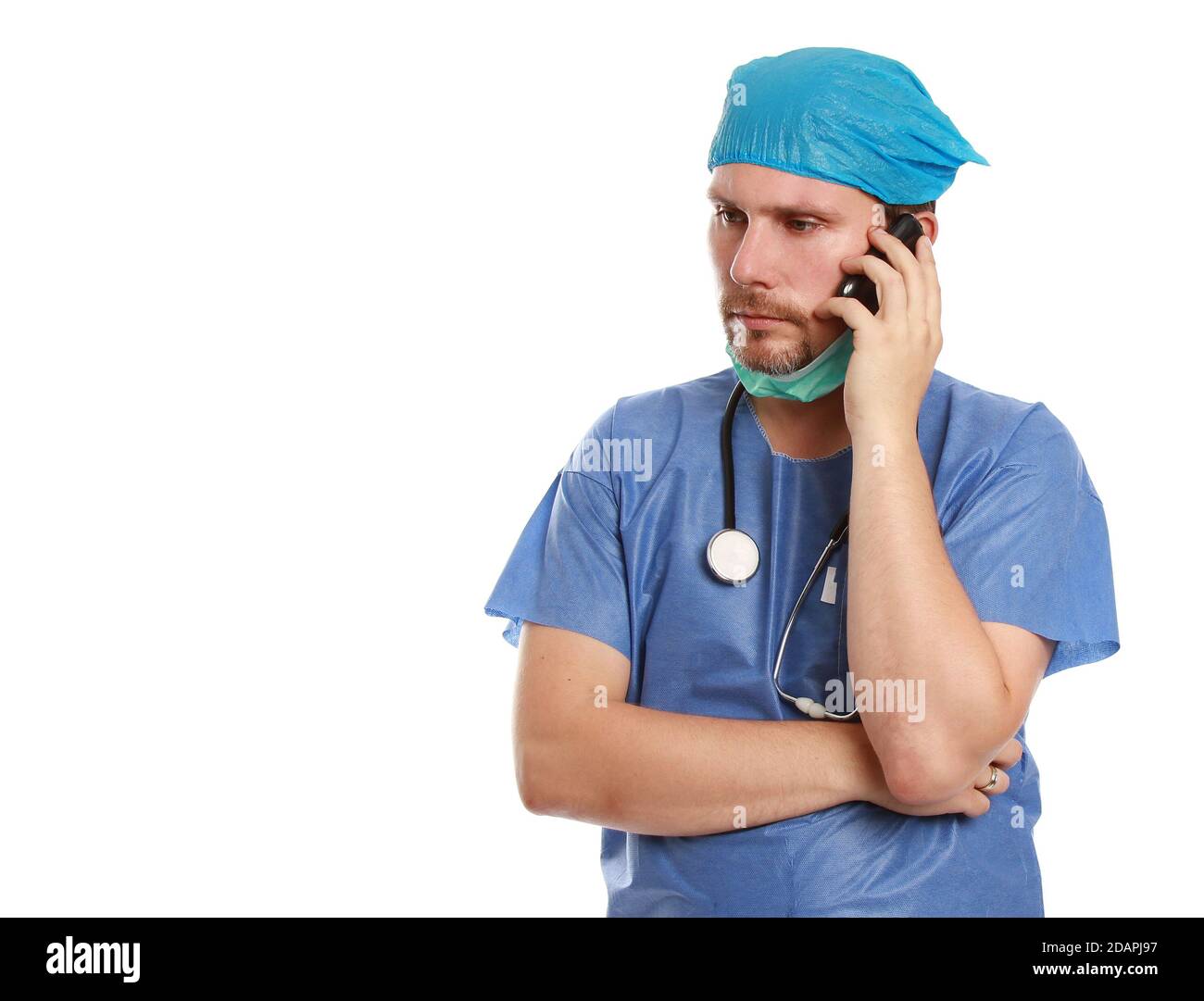 A concerned doctor speaking on the phone isolated on a white background ...