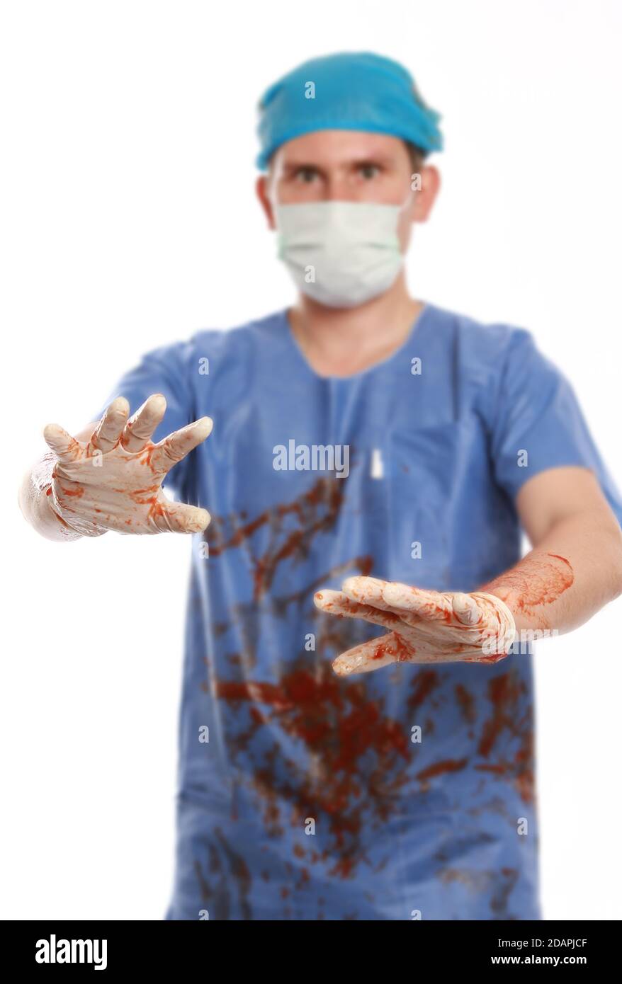A vertical shot of a bloody surgeon protecting himself after a failed ...