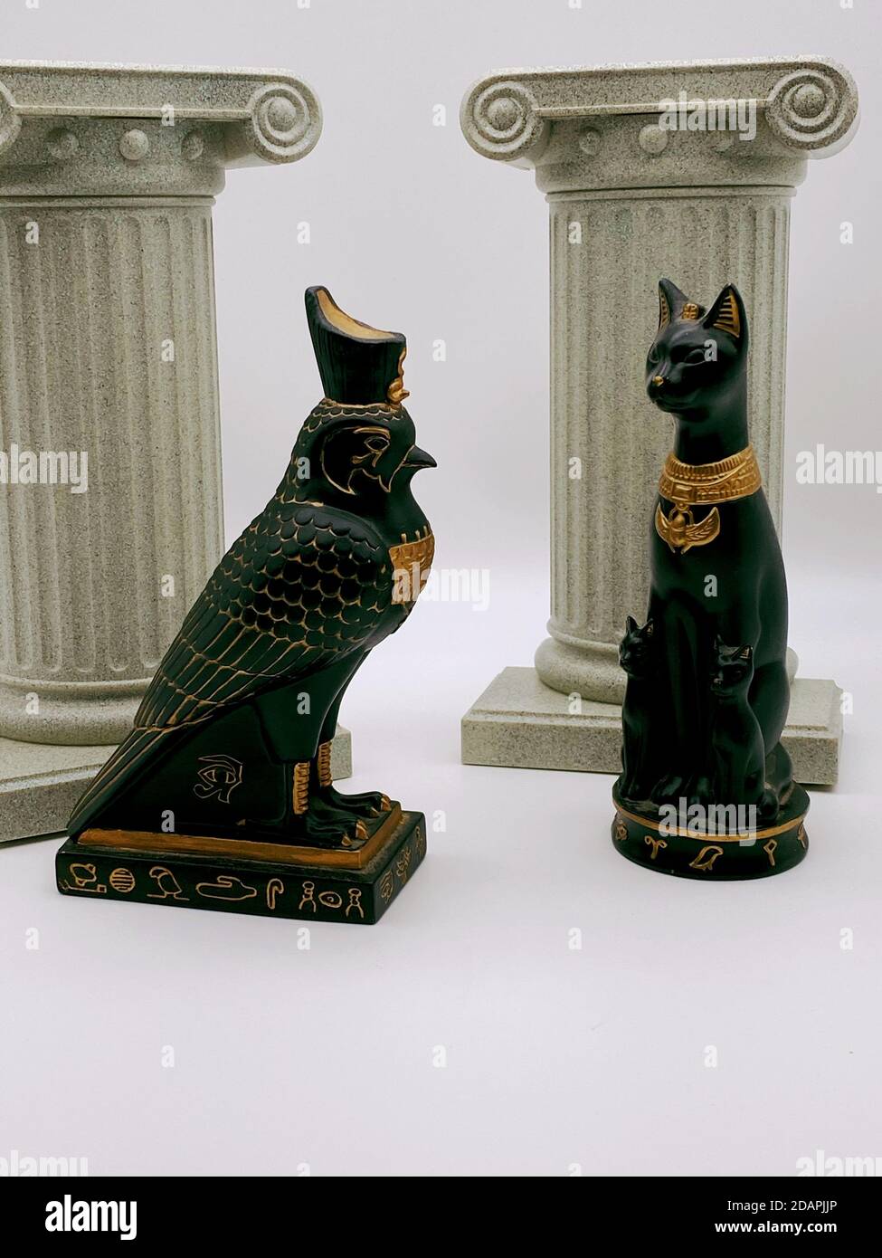 Vertical shot of an ancient Greek cat and dove statues with columns ...