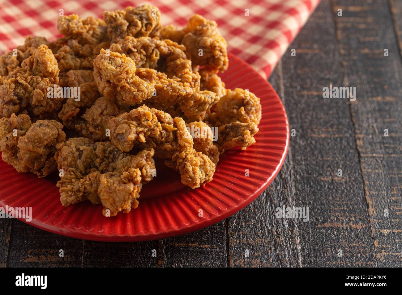 Fried and Crispy Chicken Gizzards on a Rustic Wooden Table Stock Photo ...