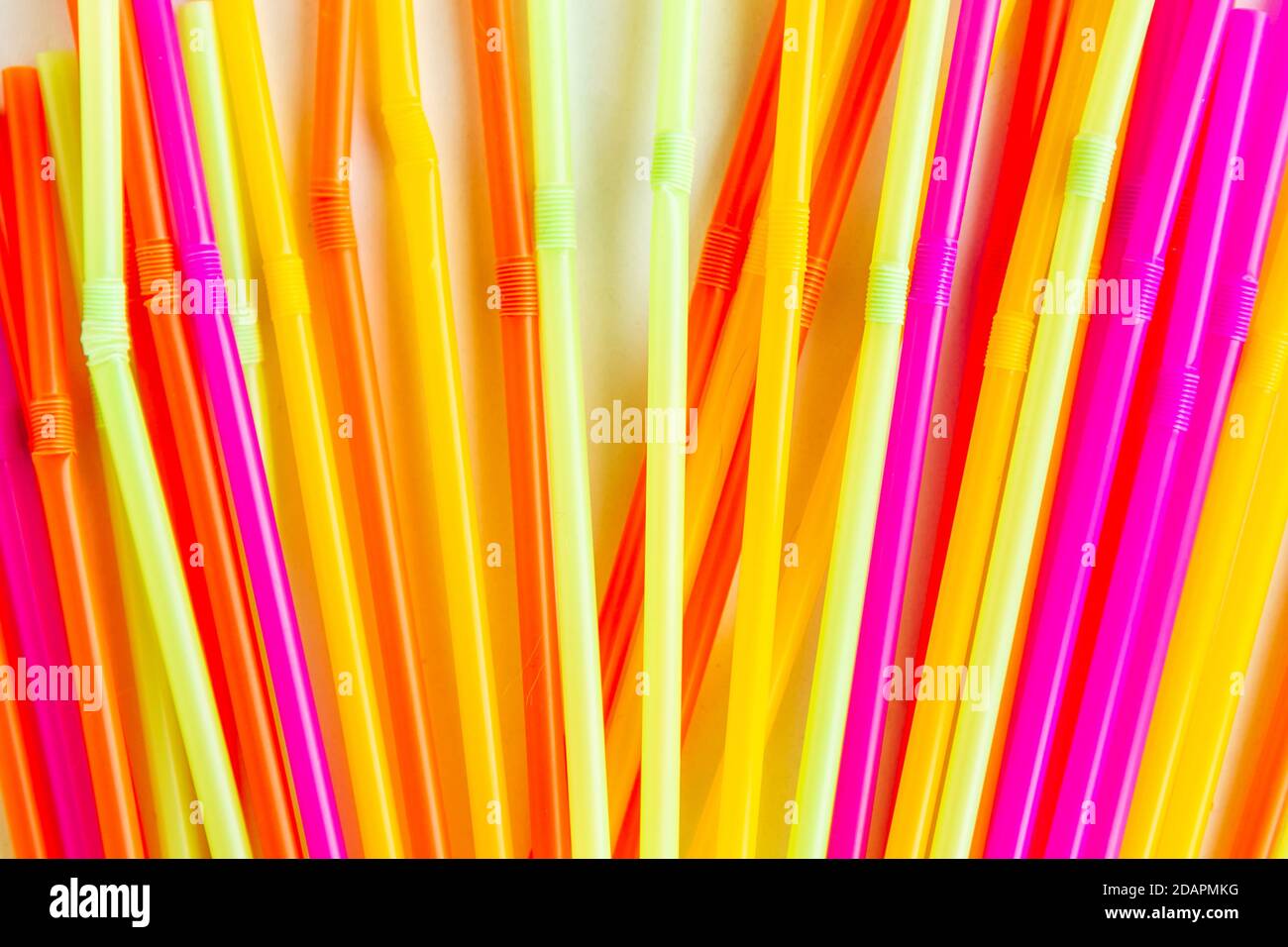 Multicolored plastic drinking cocktail straws pattern, top view. Make a ...