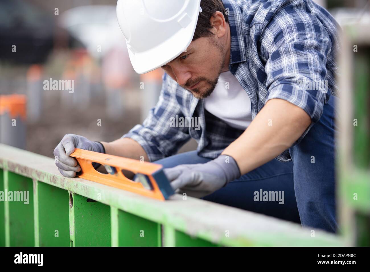 construction worker using spirit level Stock Photo - Alamy