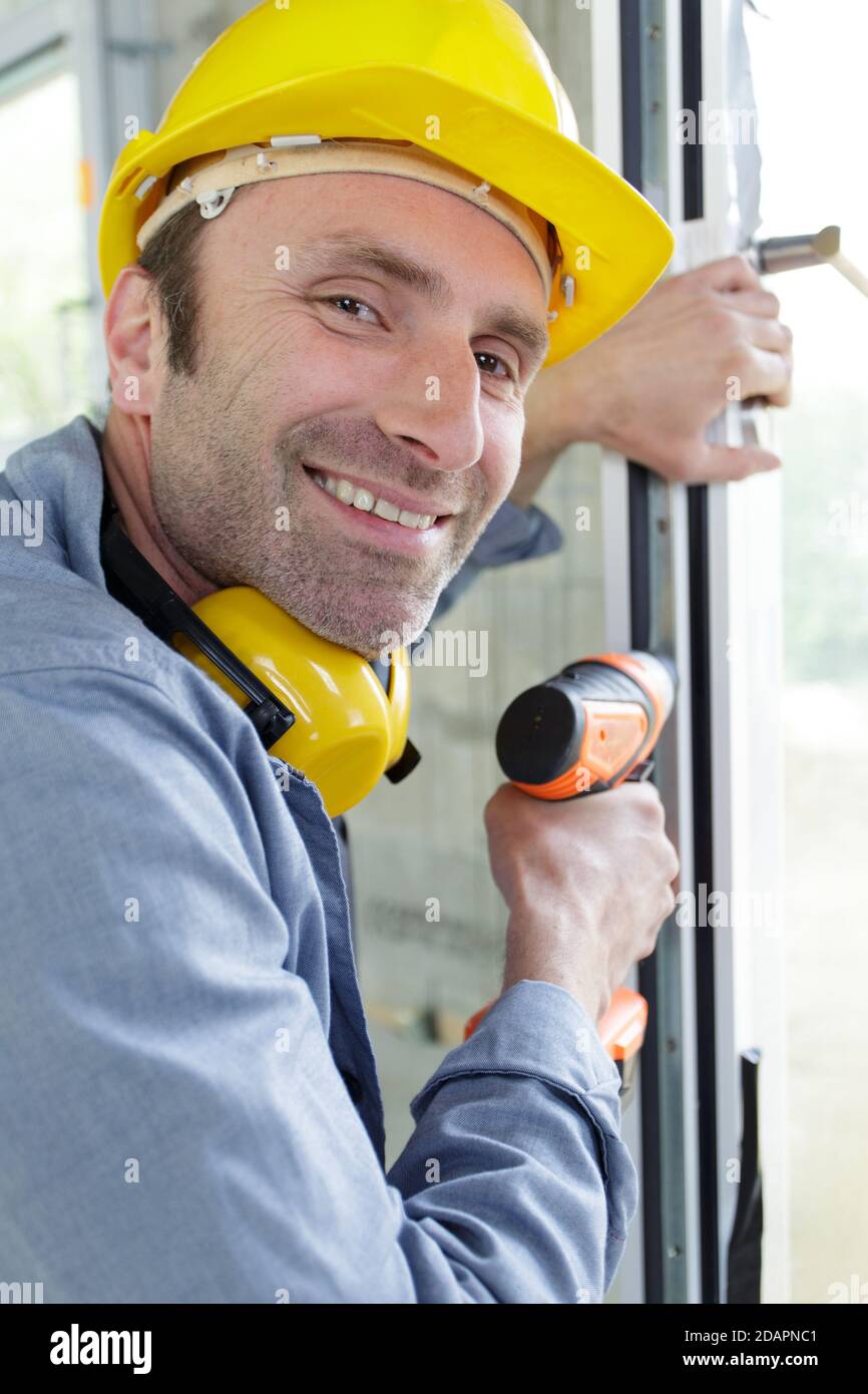 happy builder man smiling at the camera Stock Photo - Alamy