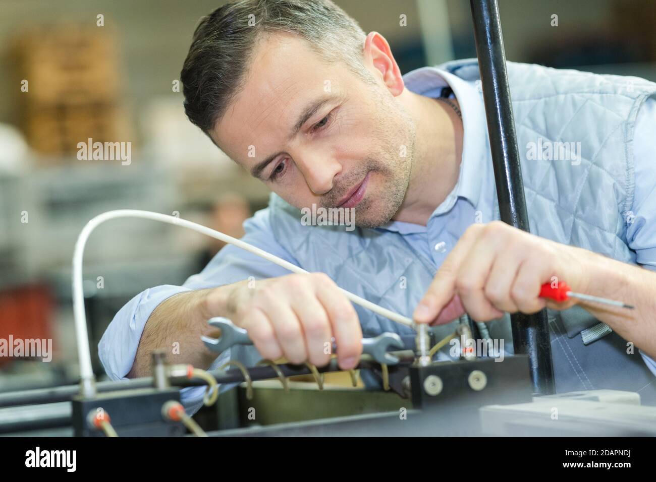 portrait of man fixing cables Stock Photo - Alamy