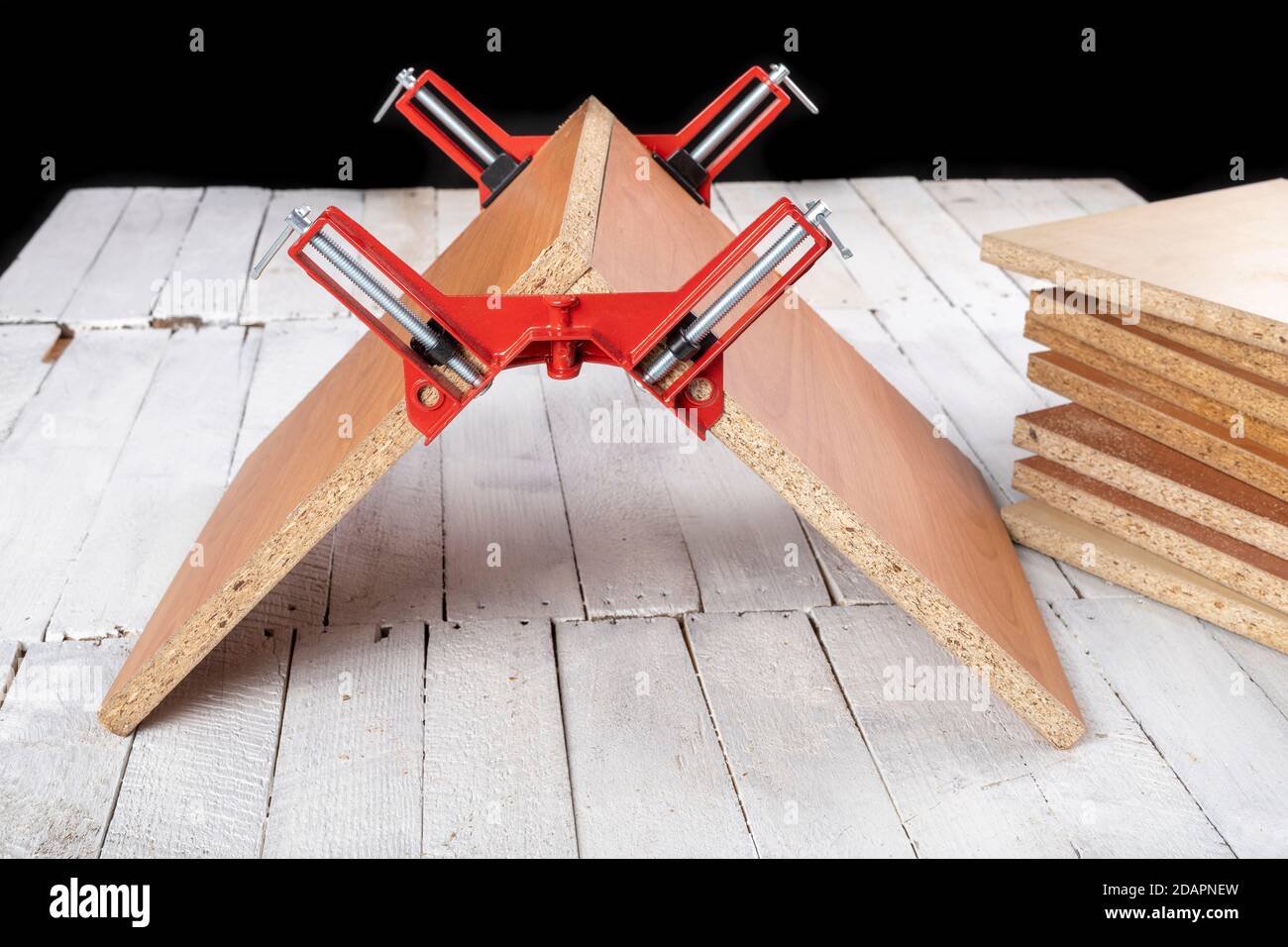 Chipboard in an angular carpentry clamp. Fixing the material for ...