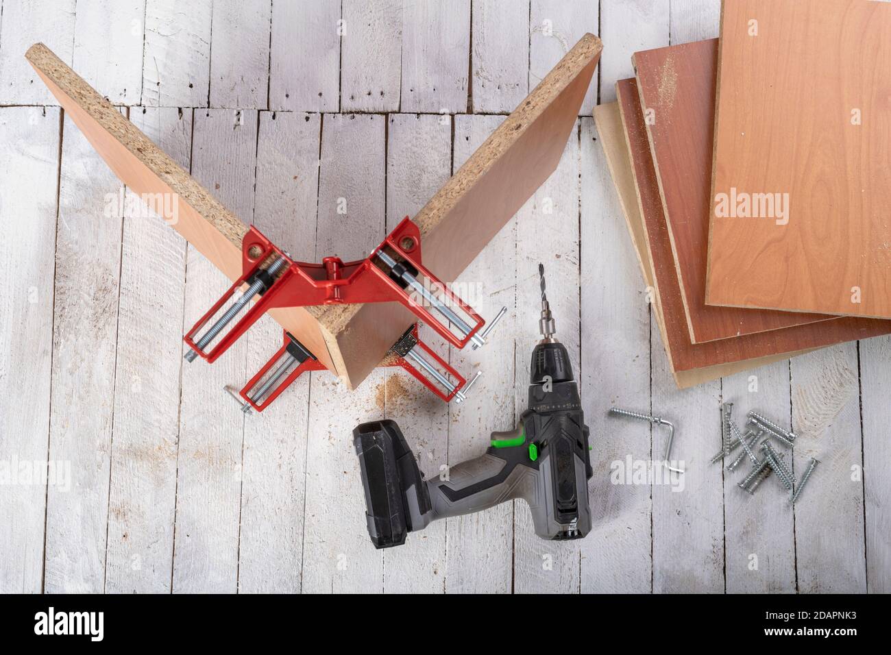 Chipboard in an angular carpentry clamp. Joining furniture boards with ...