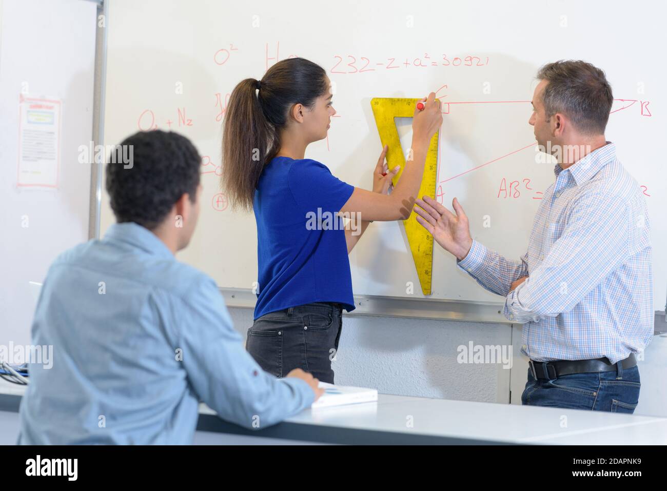 the science professor and student writing on board Stock Photo - Alamy