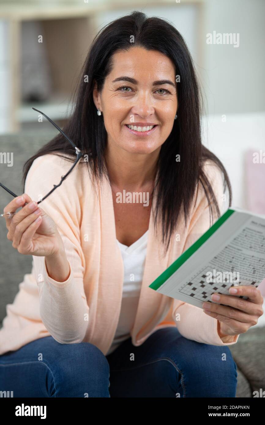 happy woman doing the crosswords Stock Photo - Alamy