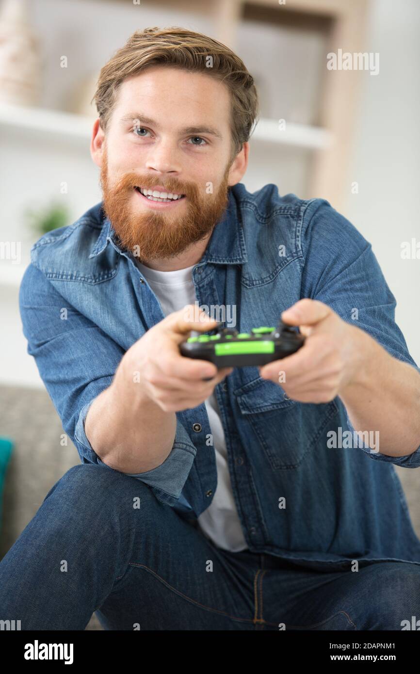 Young man using joystick joypad hi-res stock photography and images - Alamy