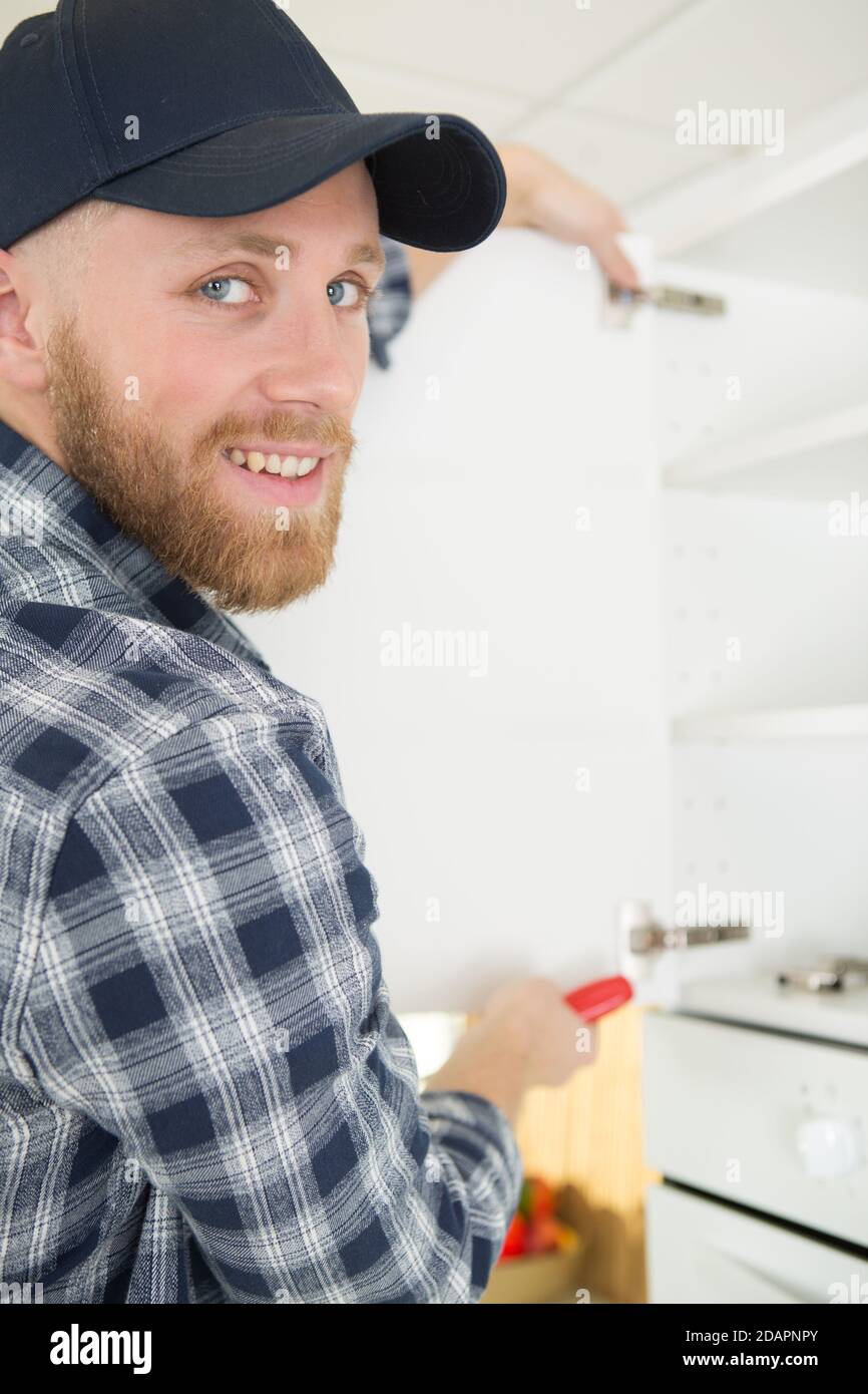 contractor repairman working in the kitchen Stock Photo - Alamy