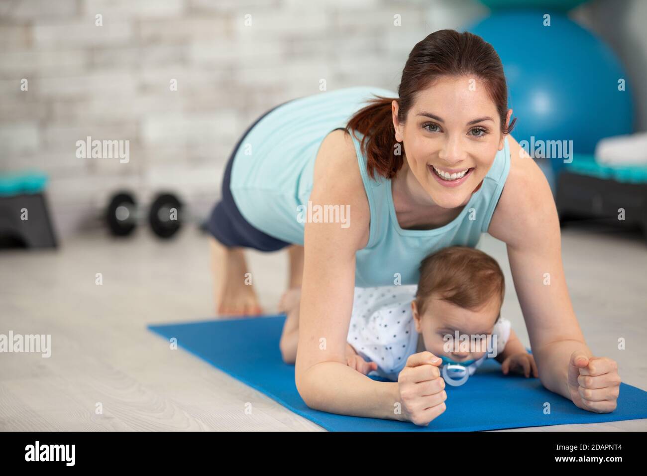 view of young mother doing plank together with her baby Stock Photo - Alamy