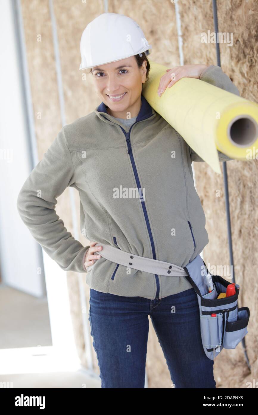 portrait of smiling female worker holding blueprints Stock Photo - Alamy