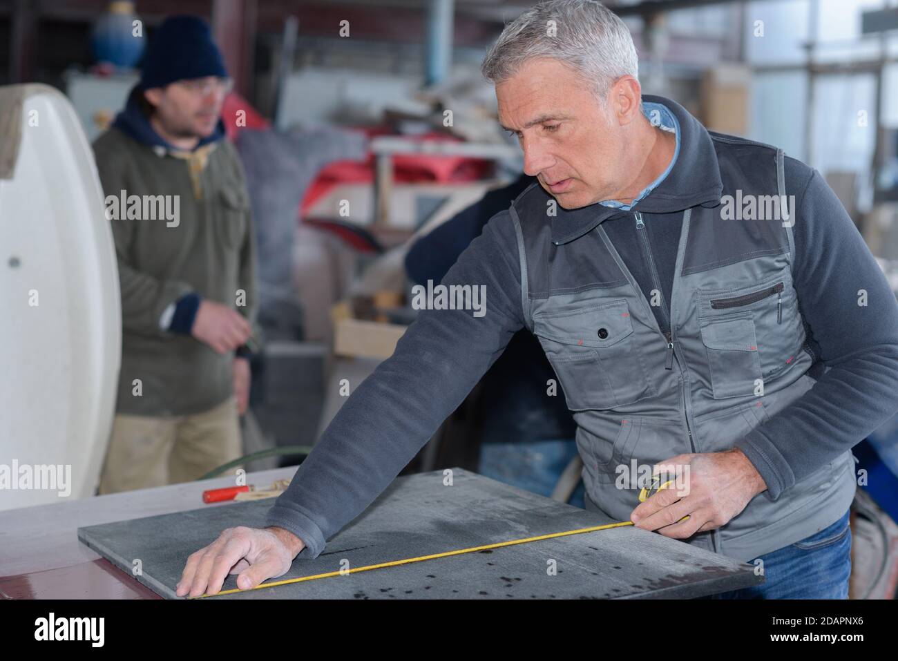 senior craftsman measuring plate in his workshop Stock Photo - Alamy