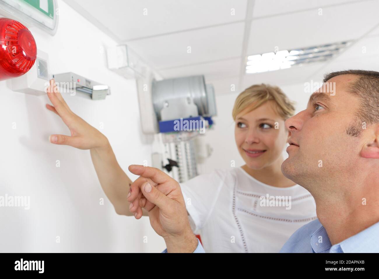 inspection of safety alarm devises mounted on a wall Stock Photo - Alamy