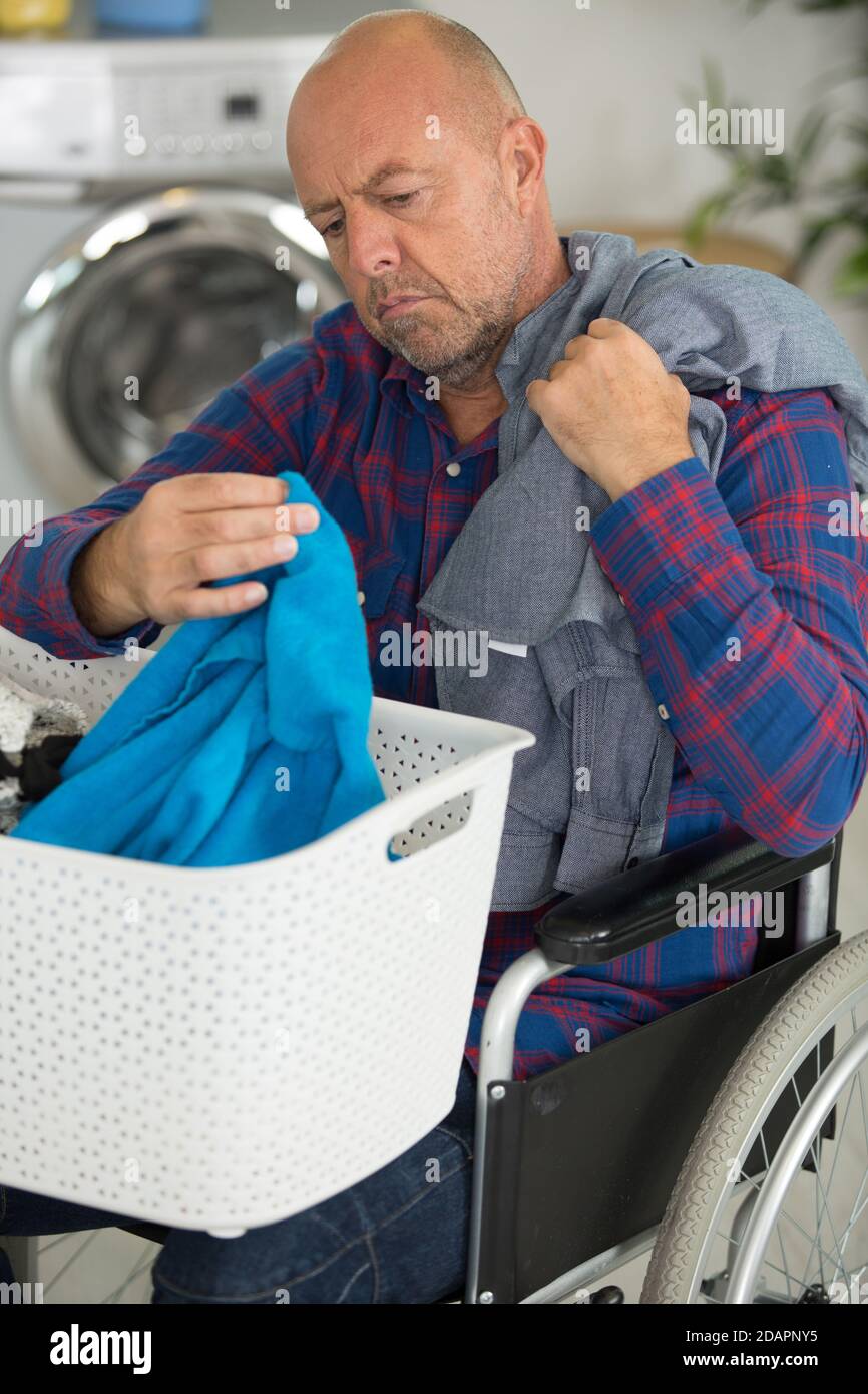 senior man in wheelchair sorting laundry Stock Photo - Alamy