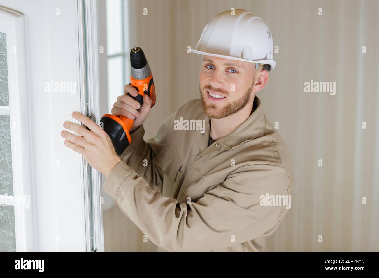 happy man using a drill Stock Photo - Alamy
