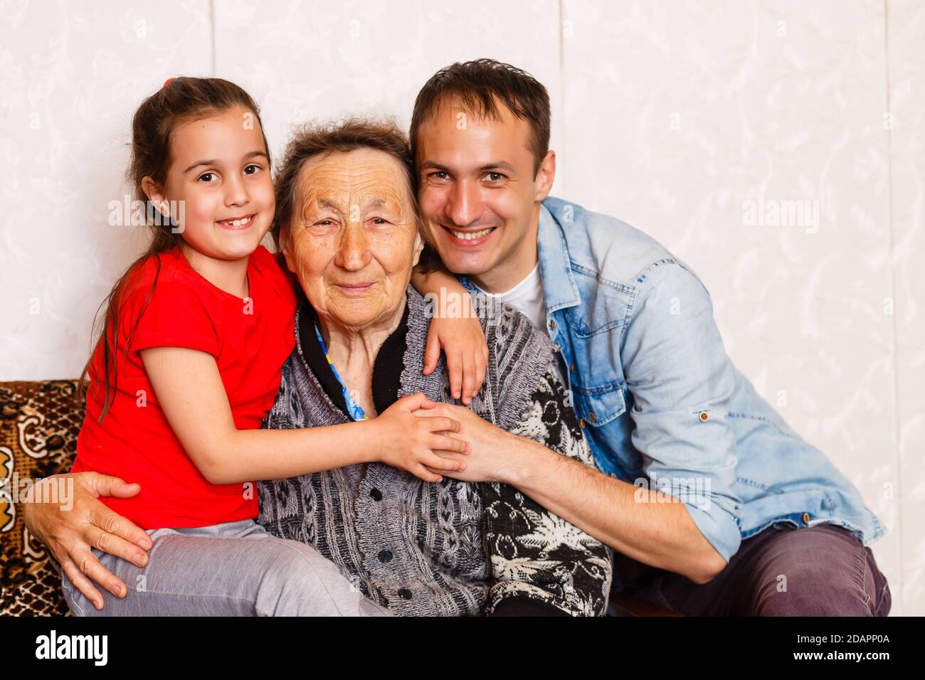 95-year-old woman and her great-granddaughter look at the camera. She ...