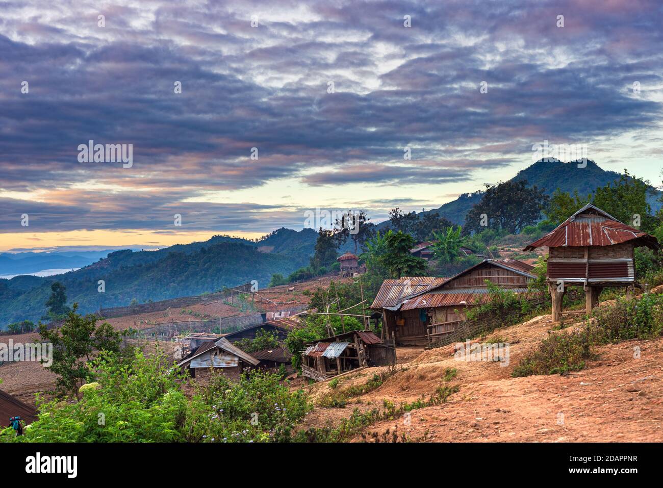 Akha village in the mountains of North Laos, sunset dramatic sky ...