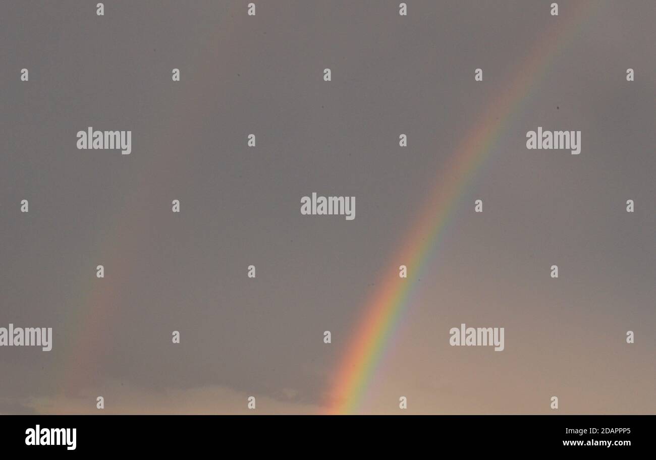 cloudy gray sky with a faint rainbow Stock Photo - Alamy