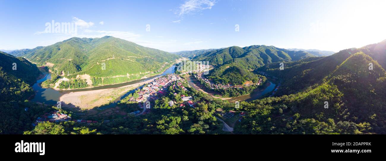 Muang Khua village in the mountains of North Laos, clear blue sky ...