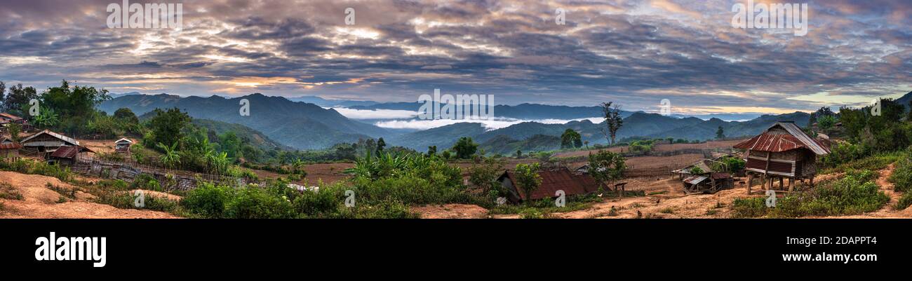 Akha village in the mountains of North Laos, sunset dramatic sky ...